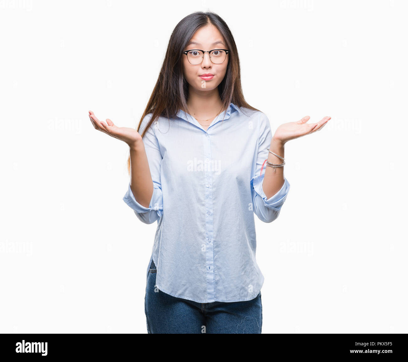 Young asian business woman wearing glasses over isolated background ...