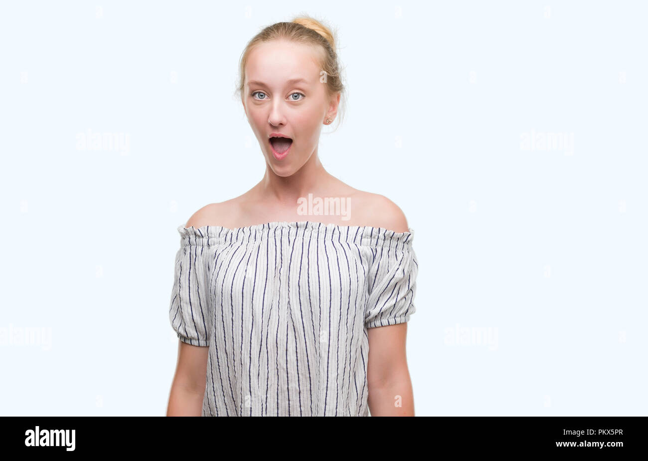 Blonde teenager woman wearing a bun scared in shock with a surprise ...
