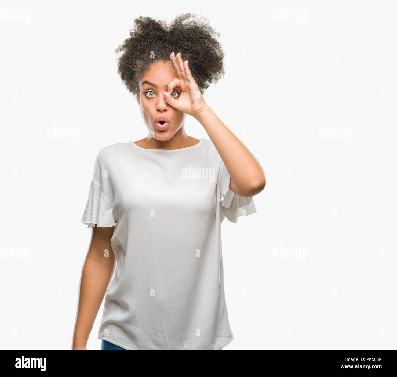 Young afro american woman over isolated background doing ok gesture ...