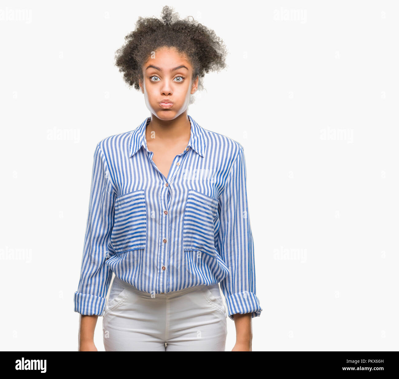 Young afro american woman over isolated background puffing cheeks with ...