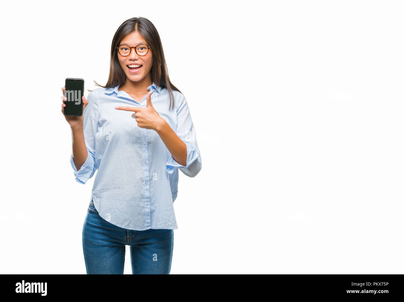 Young asian woman showing smartphone blank screen over isolated ...