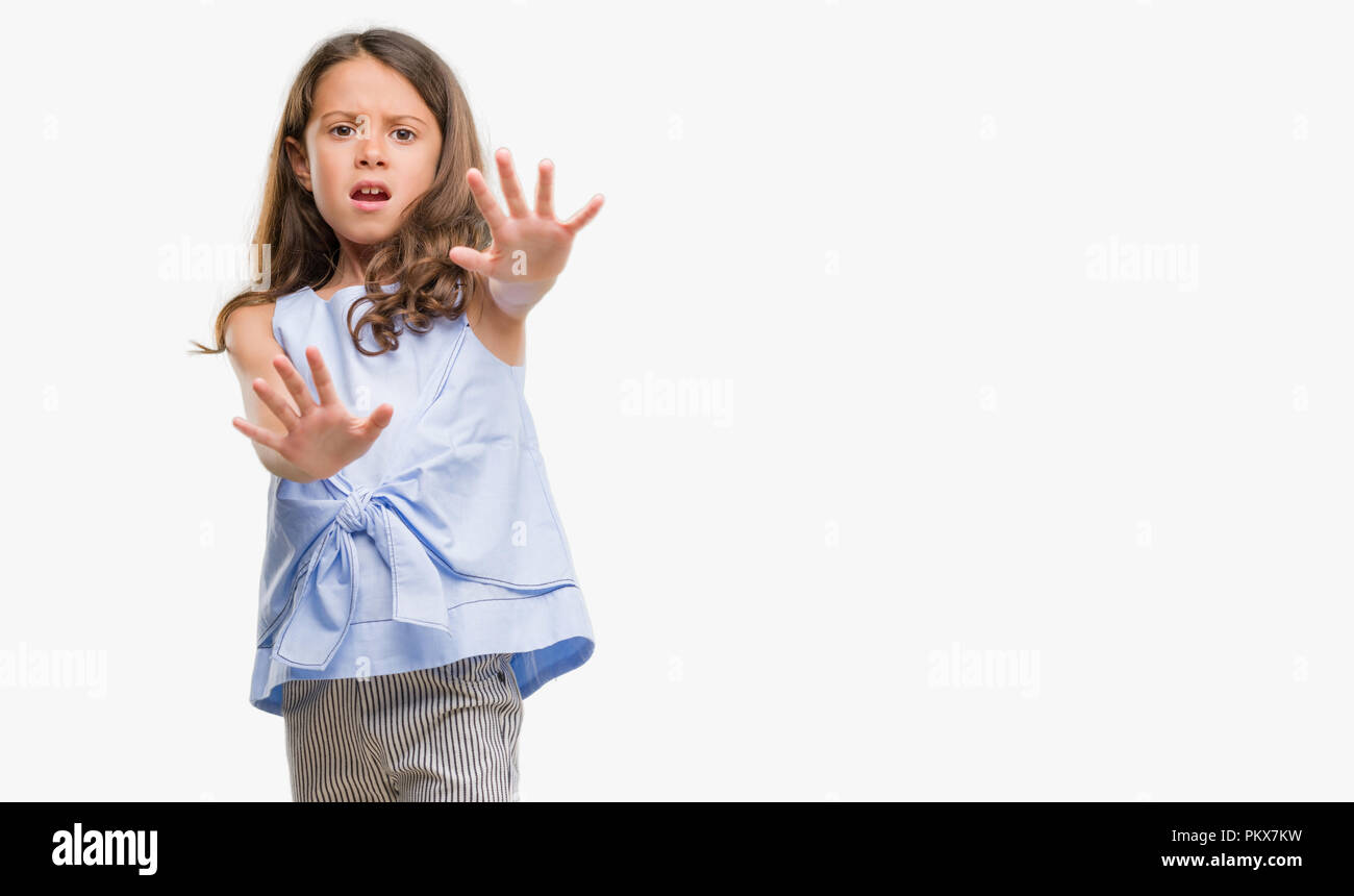 Brunette hispanic girl afraid and terrified with fear expression stop ...