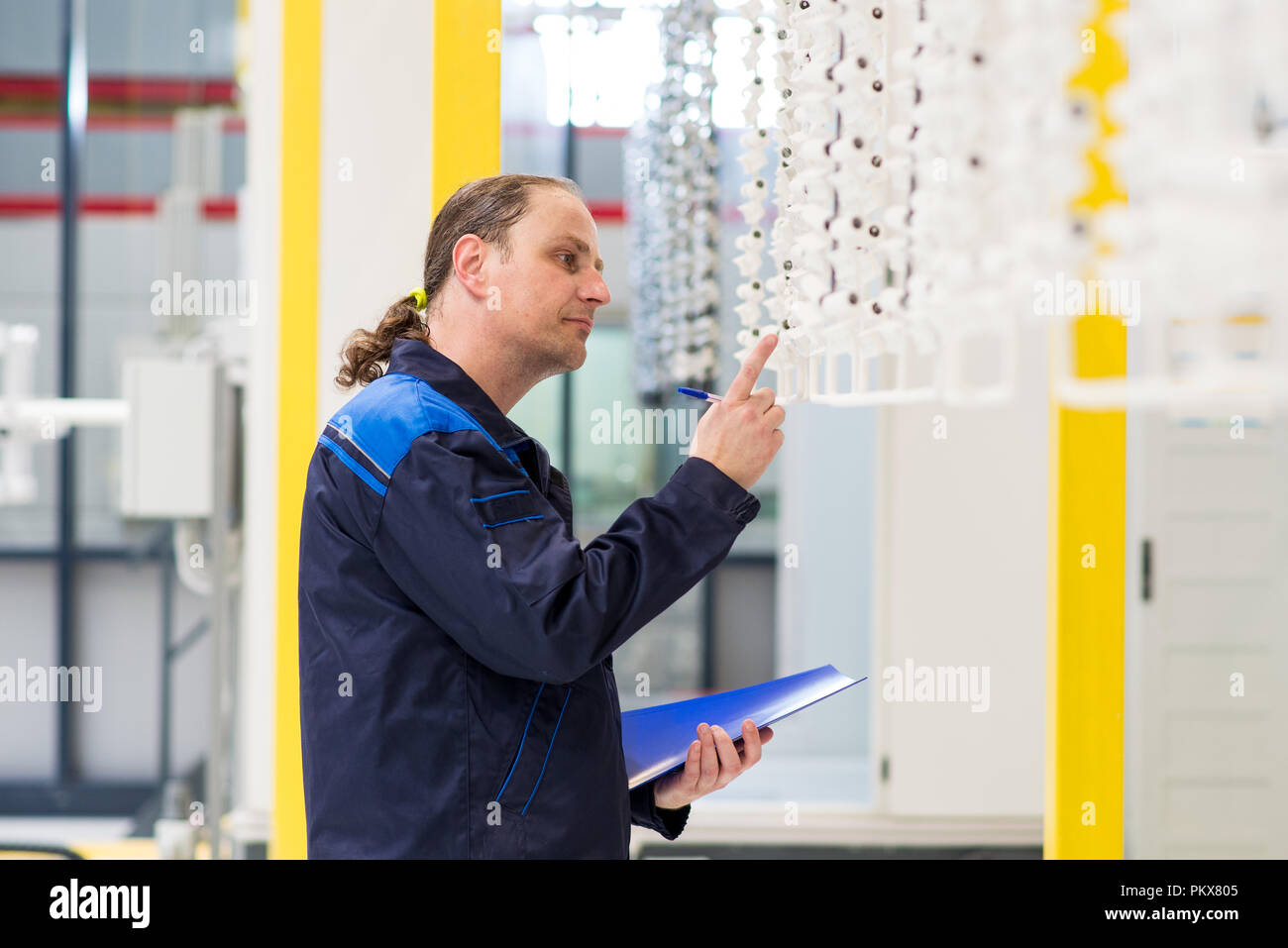 Factory worker checking products on production line. Worker taking ...