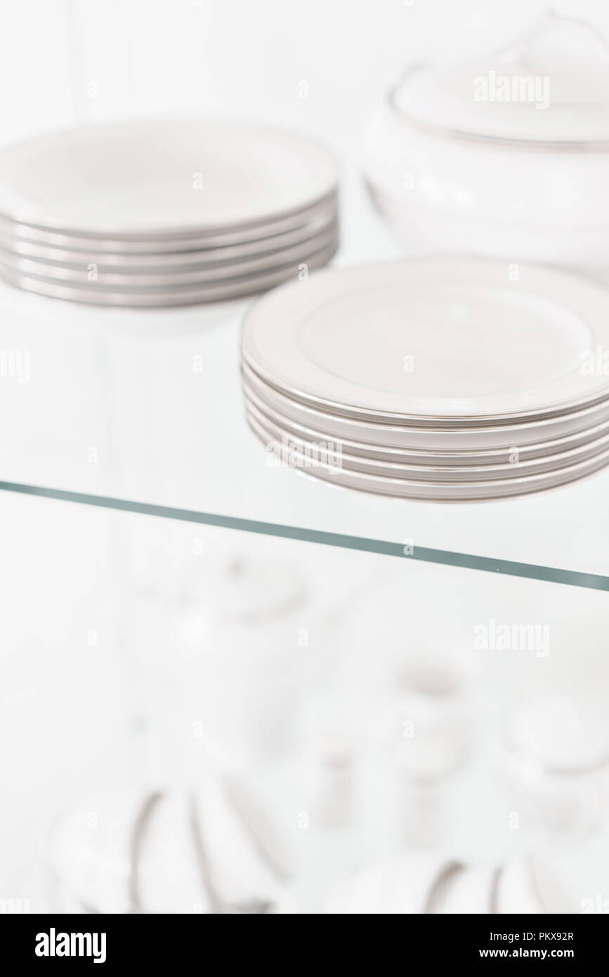 Variety of dishes in the showcase . a stack of white dishes and soup ...