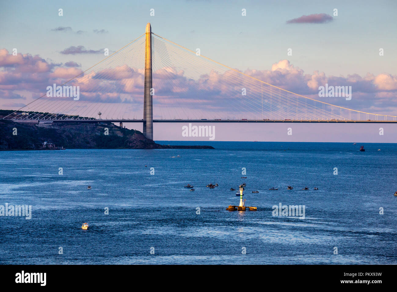 Zoomed view of small fishing boats with The Yavuz Sultan Selim Bridge ...