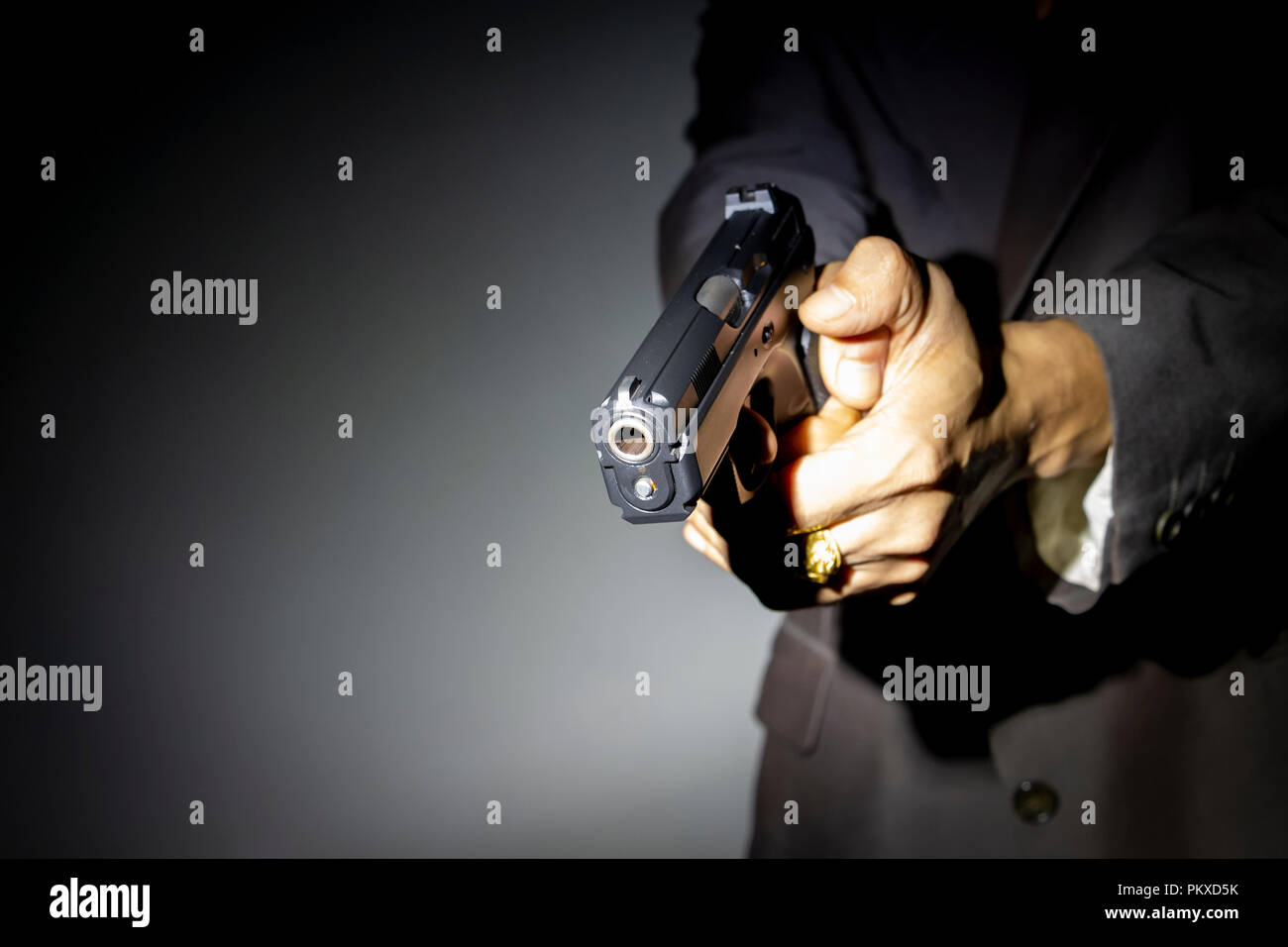 Close up male hand holding gun for shooting Stock Photo - Alamy