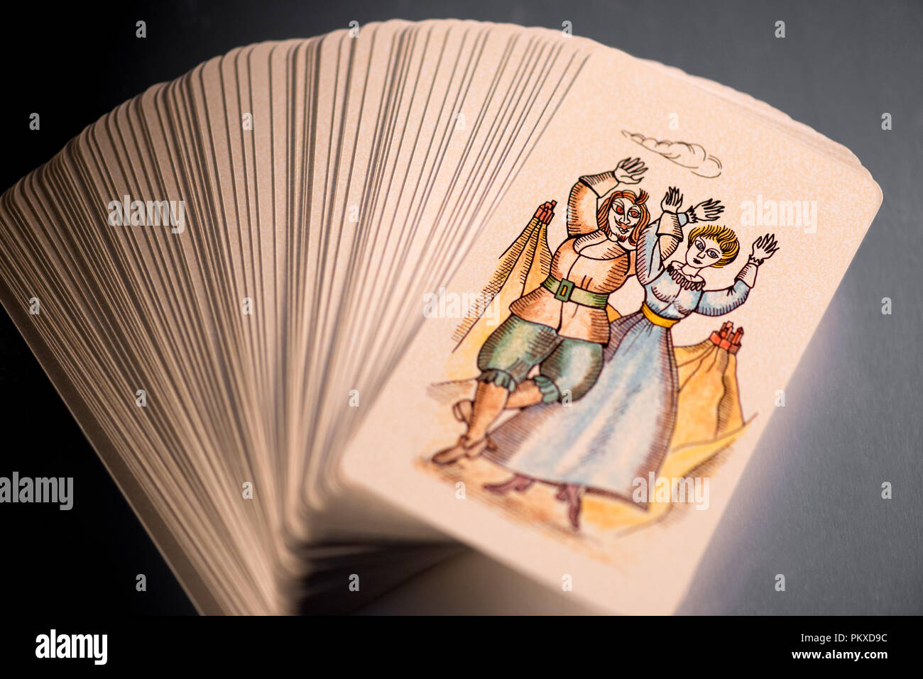 Pack of fanned out tarot cards with a pictorial Happiness card on top ...