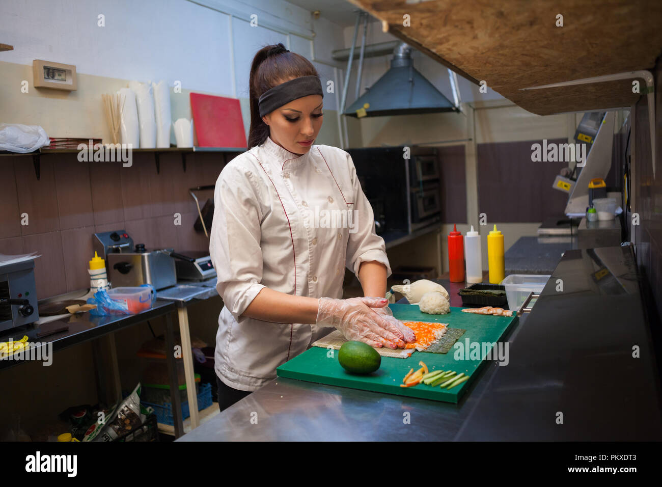 Woman cooking salmon on sushi hi-res stock photography and images - Alamy