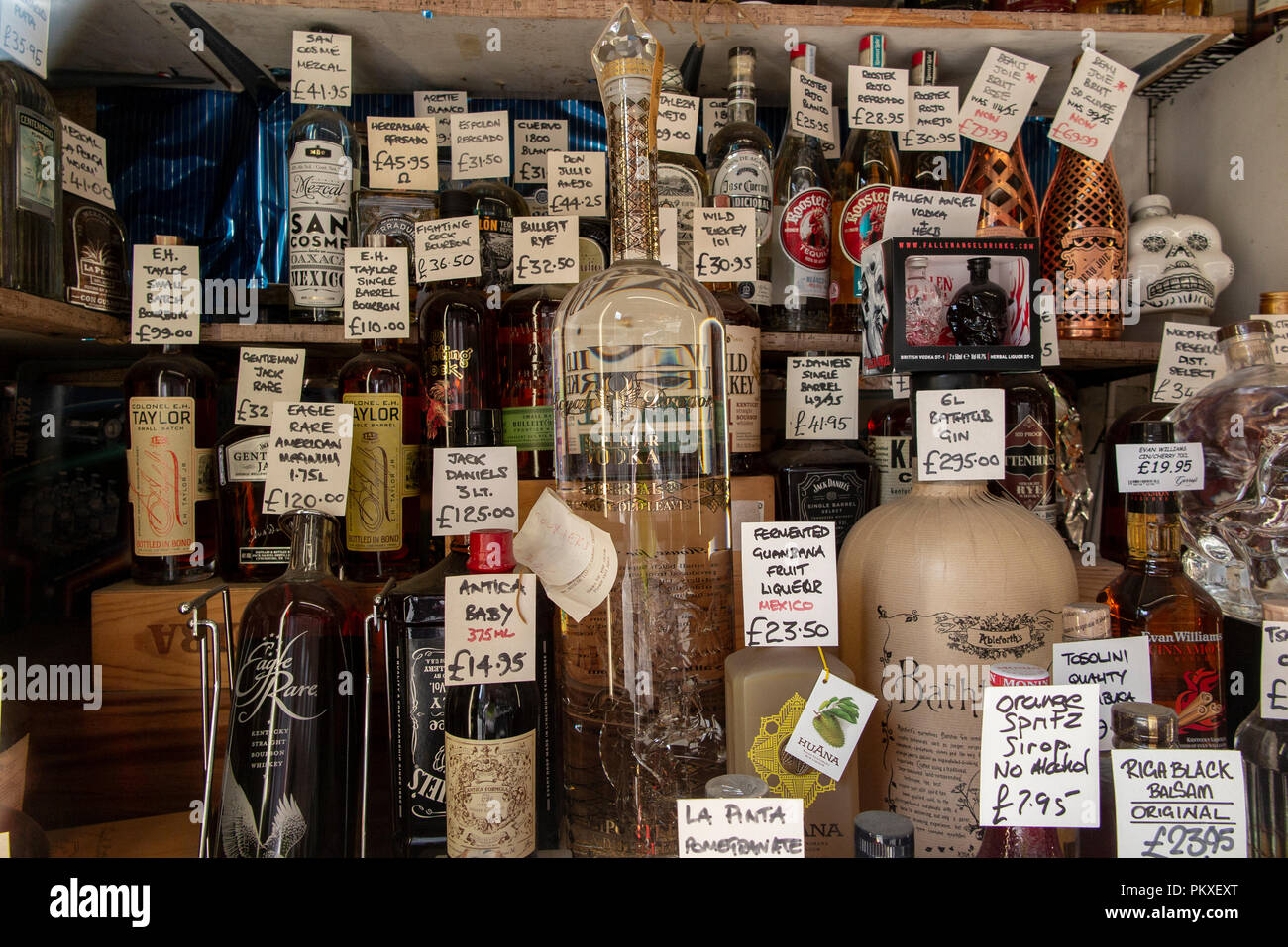 An off licence shop window with exotic spirits in Soho, London Stock ...