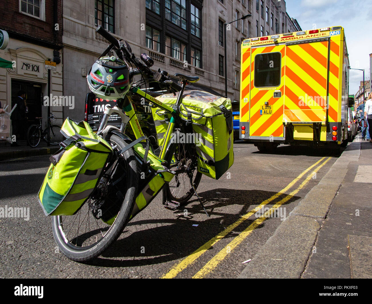A paramedic with his bike parked behind an ambulance in soho, london ...