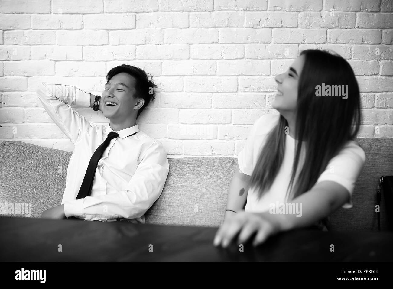 A pair of young people talking Stock Photo - Alamy