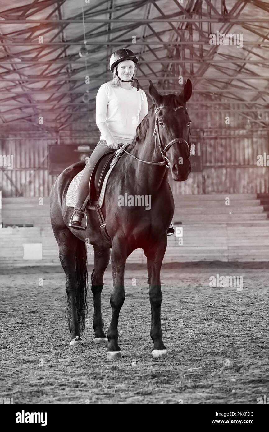 Young people on a horse training in wooden arena Stock Photo - Alamy