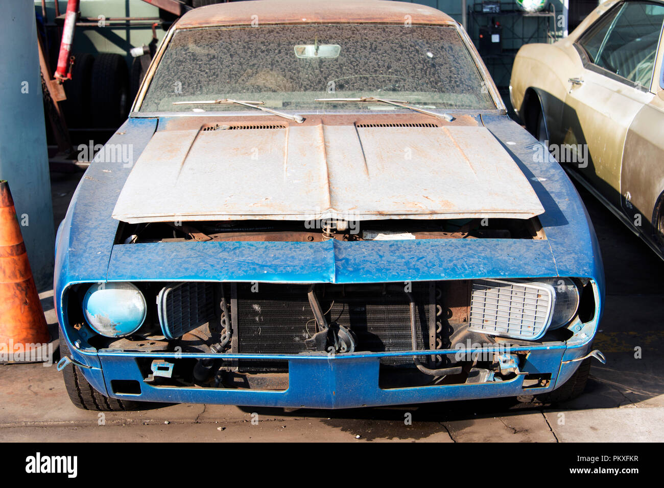 A view of classic vintage damaged American car in a garage Stock Photo ...