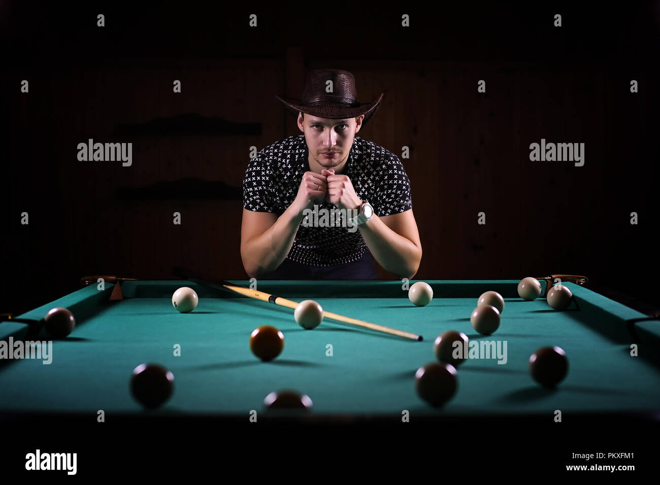 A man with a beard plays a big billiard. Party in a 12-foot pool Stock ...