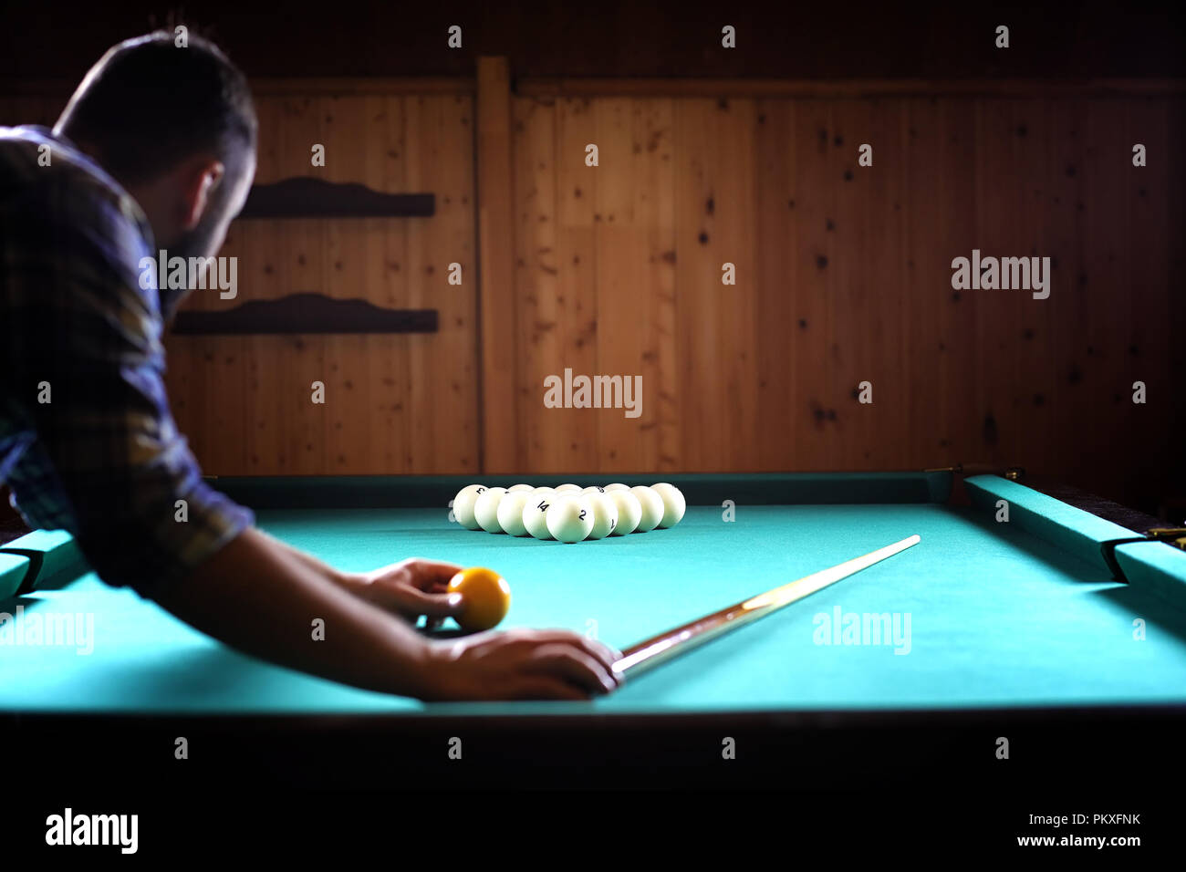 A man with a beard plays a big billiard. Party in a 12-foot pool Stock ...