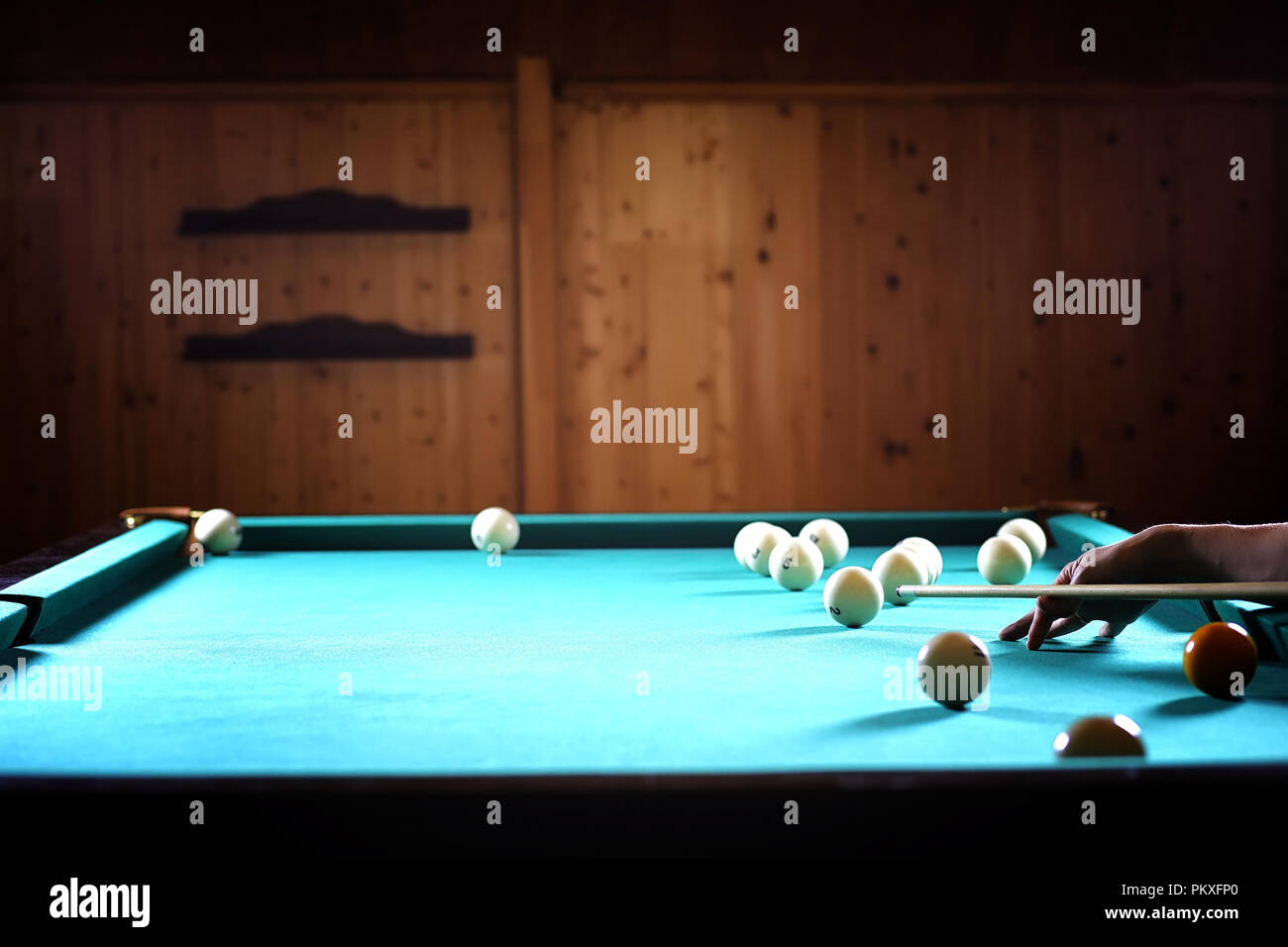 A man with a beard plays a big billiard. Party in a 12-foot pool Stock ...