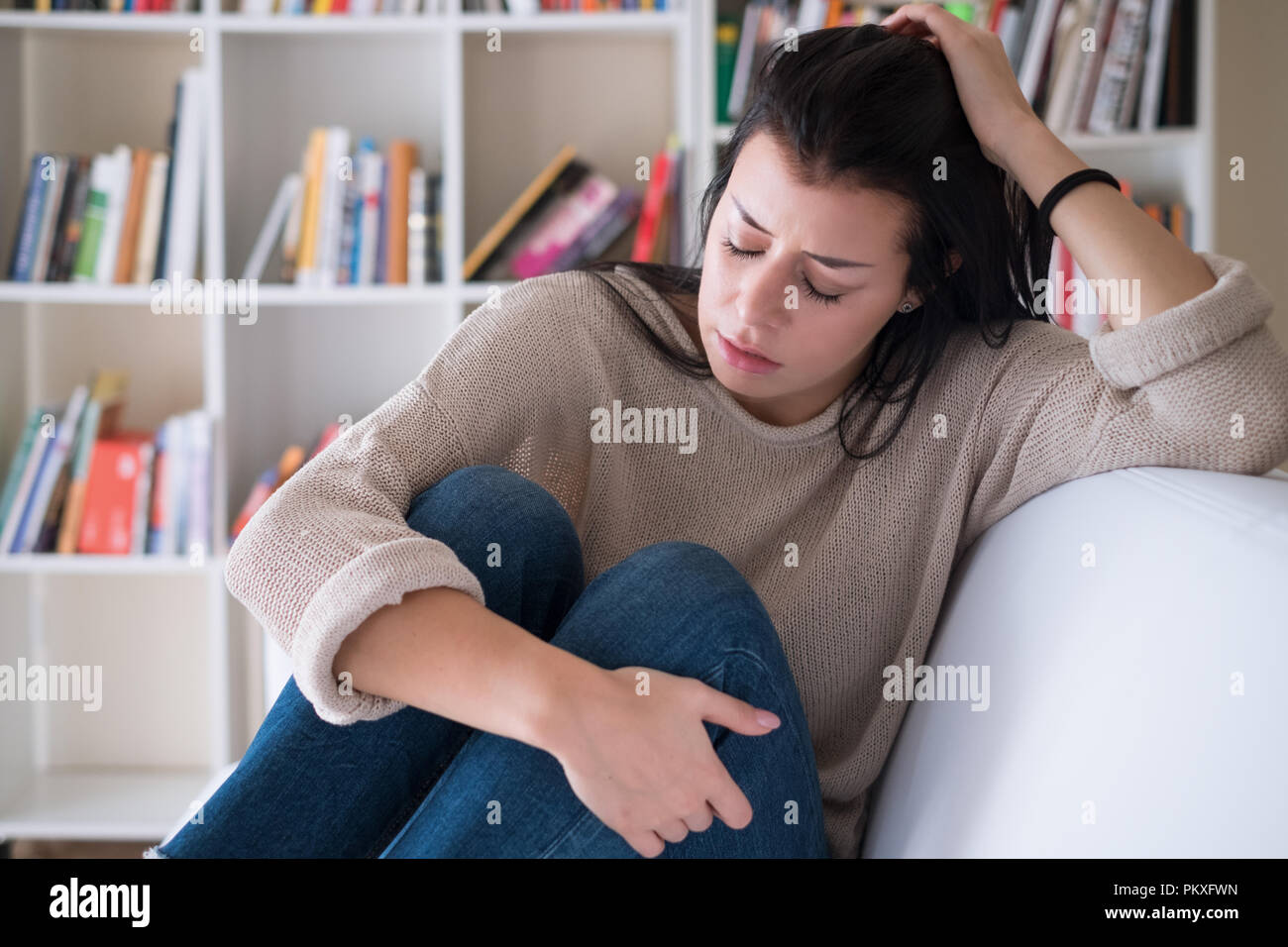 Sad young woman feeling lonely thinking about relationship problems ...