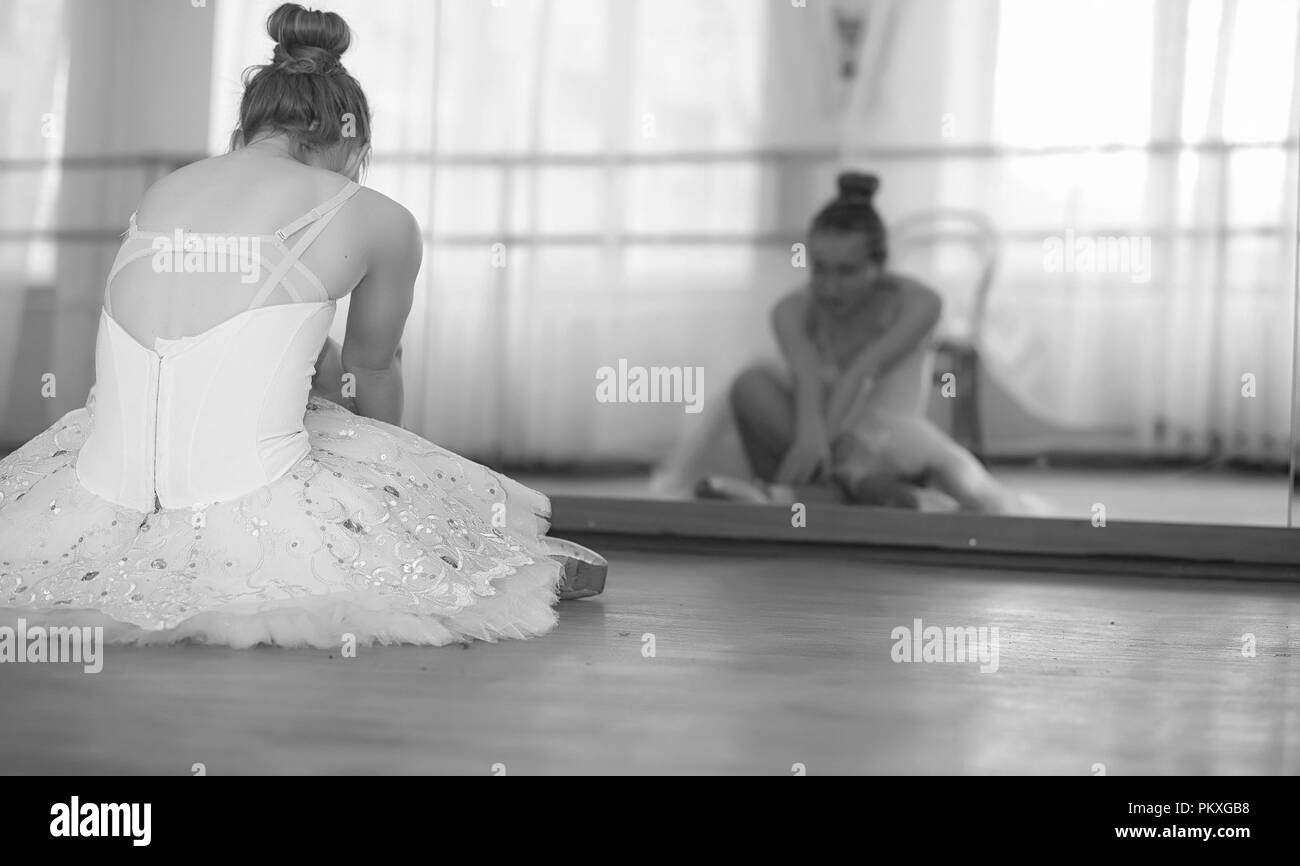 Young ballet dancer on a warm-up. The ballerina is preparing to Stock ...