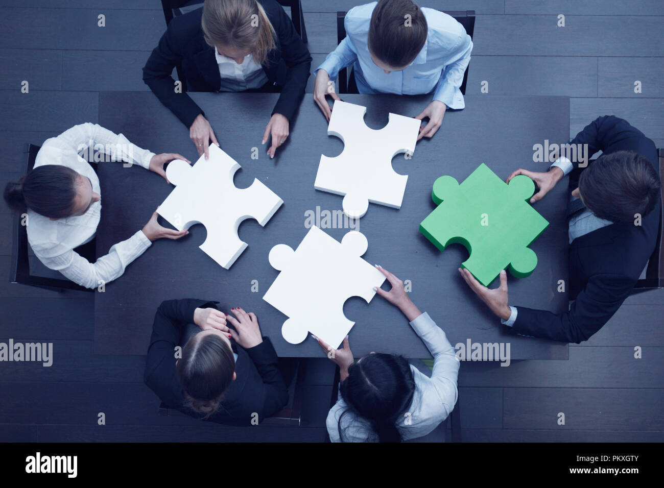 Group of business people assembling jigsaw puzzle, team support and ...
