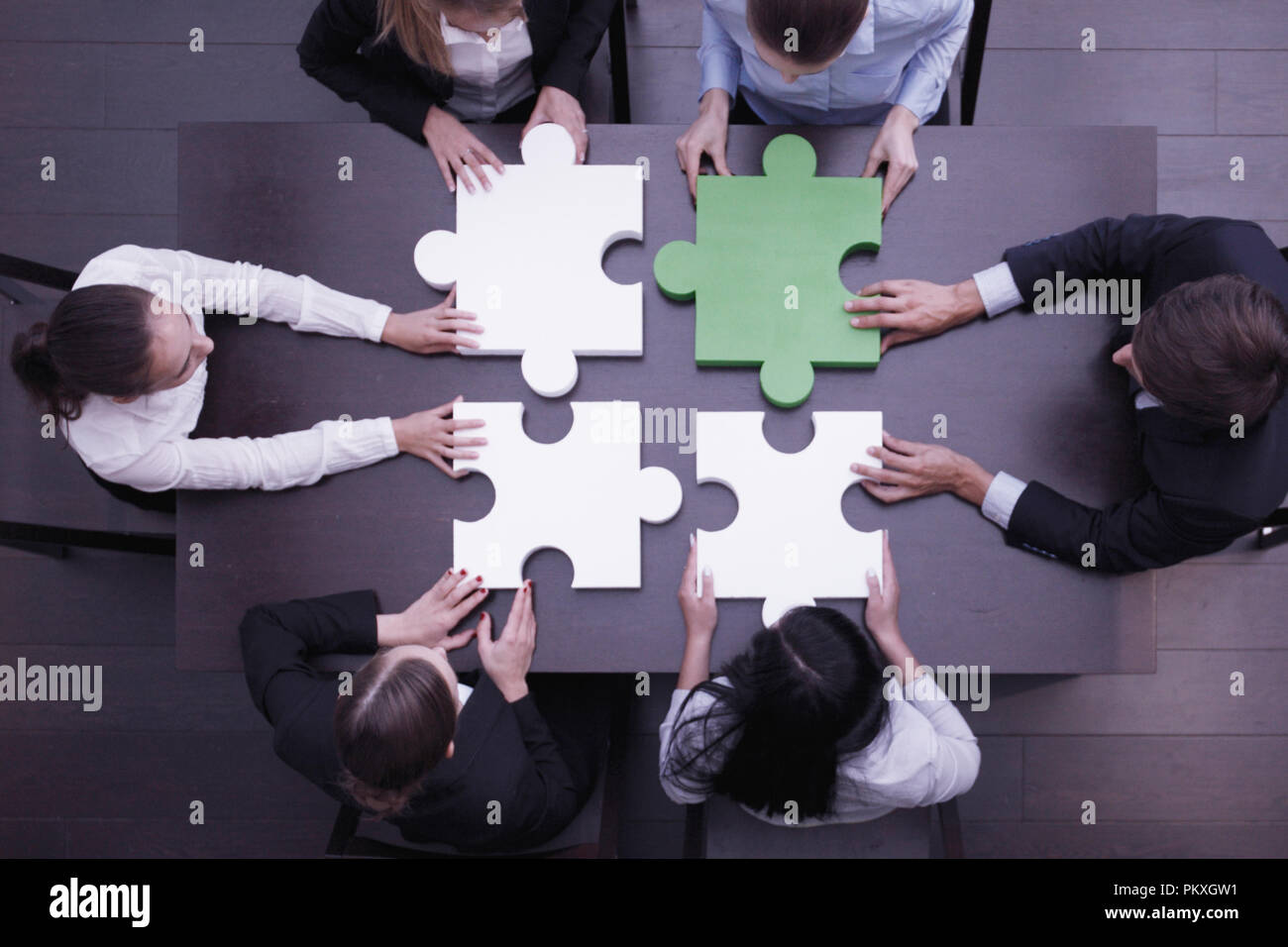 Group of business people assembling jigsaw puzzle, team support and ...