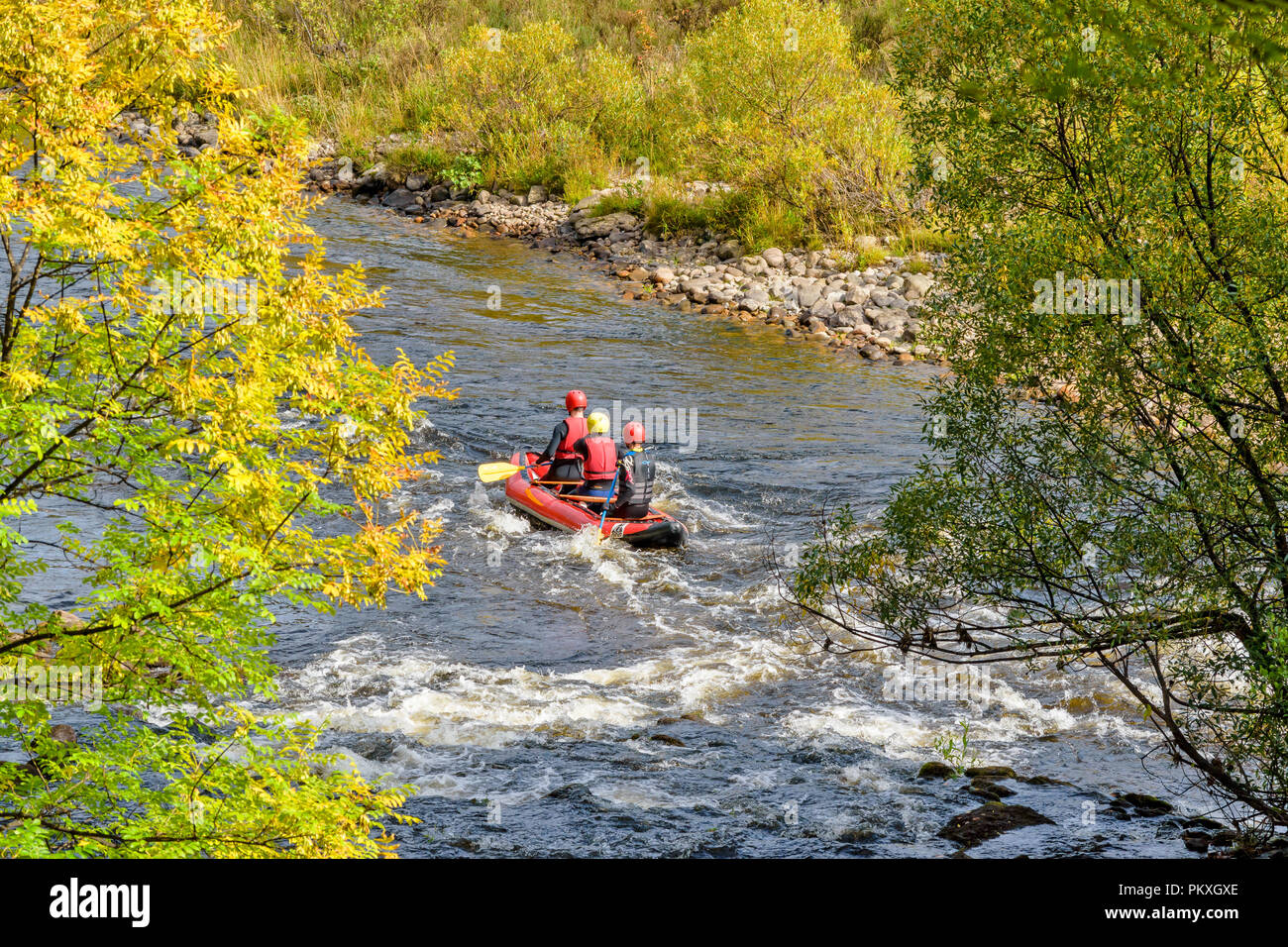 RIVER SPEY SCOTLAND AUTUMNAL TREES AND INFLATABLE CANOE OR RAFT WITH ...