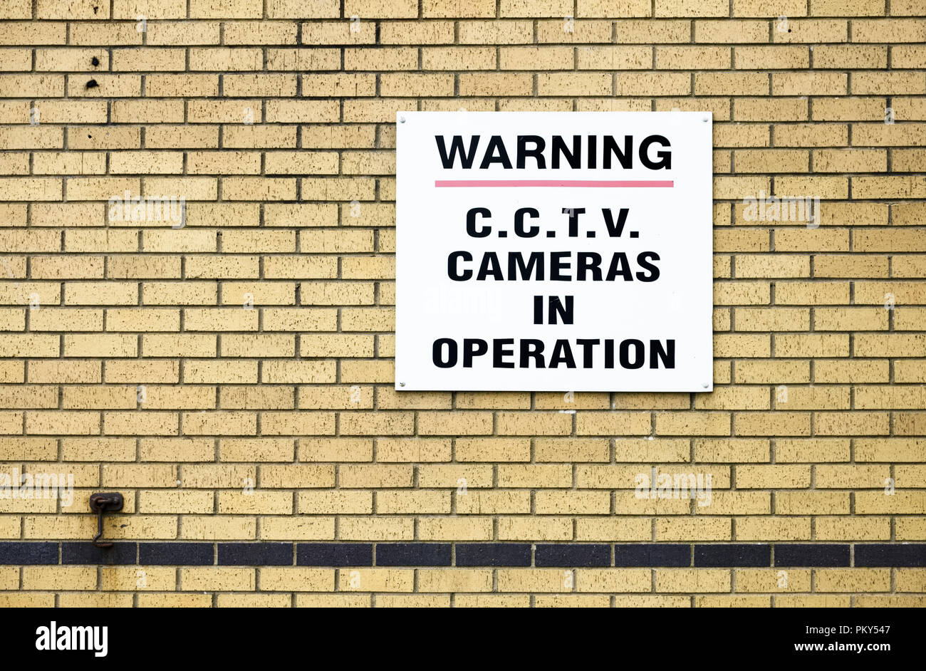 CCTV camera in operation sign on brick wall Stock Photo - Alamy