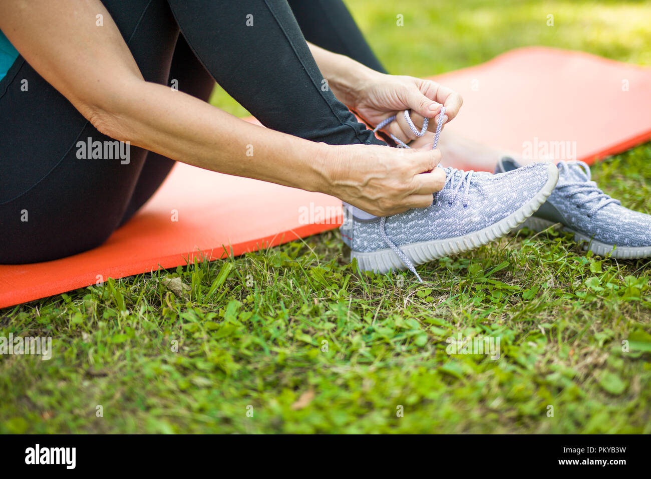 Close up view at woman wearing sport shoes at outdoor Stock Photo - Alamy