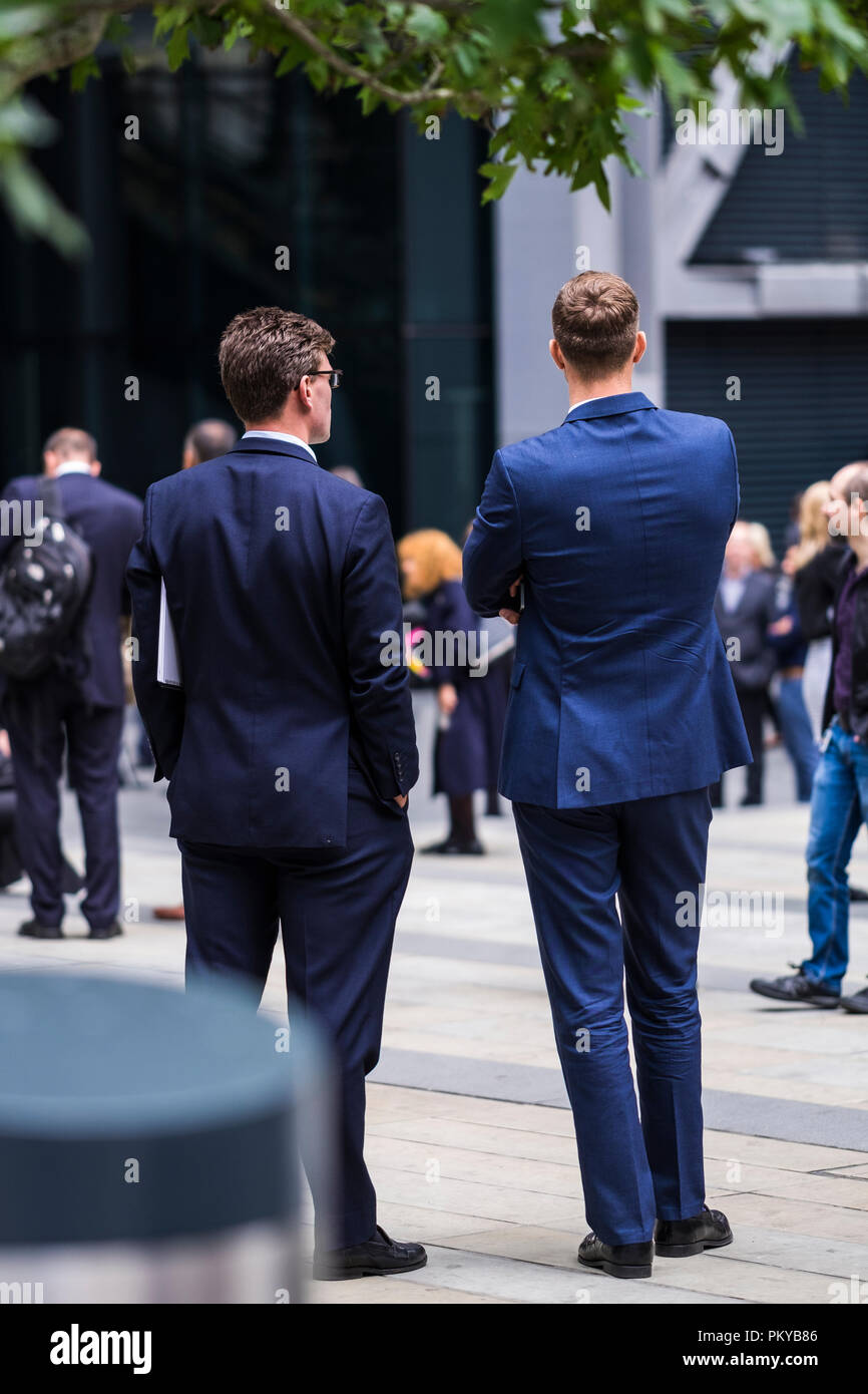 Two City of London workers pause on the Street, London, England, U.K ...