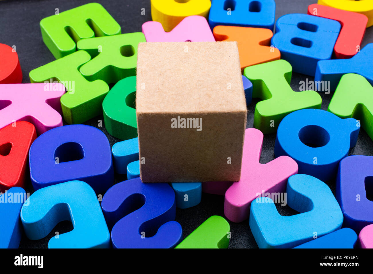Cardboard box cube and Colorful Letters of Alphabet Stock Photo - Alamy