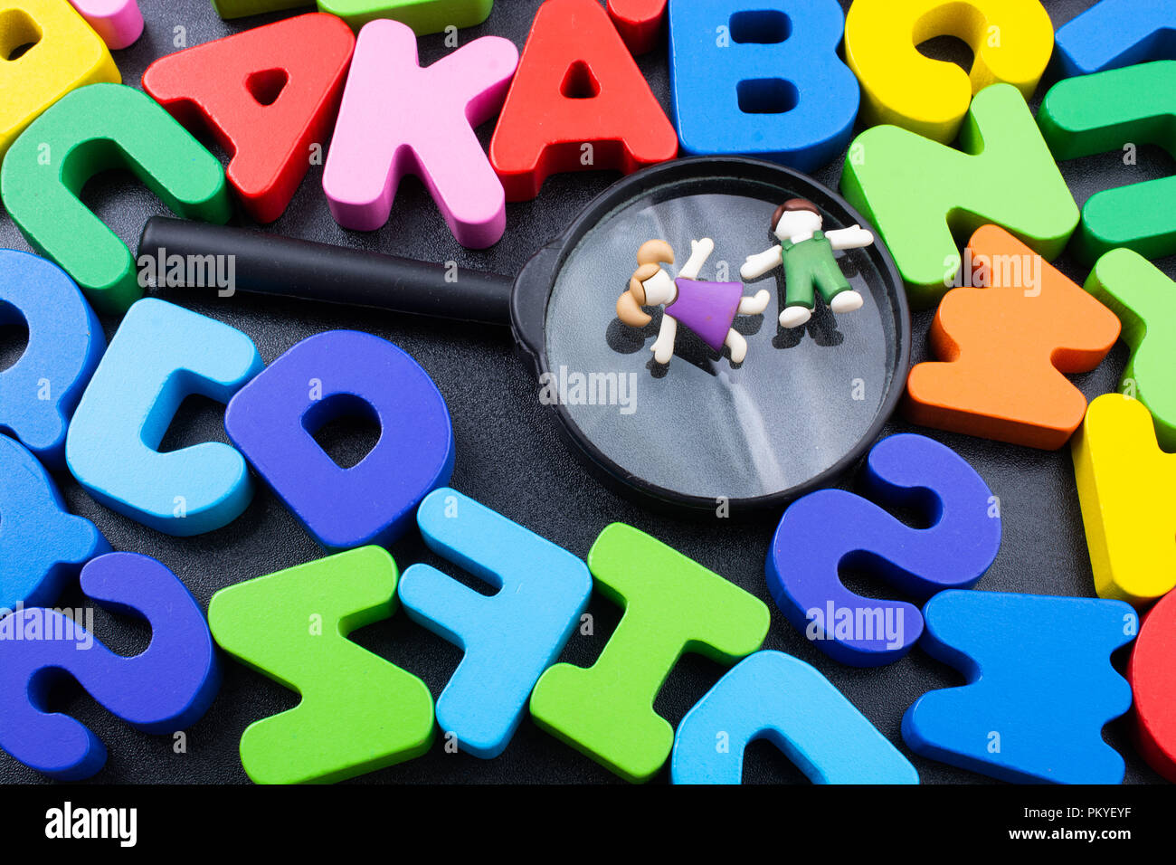 Kids over Magnifying glass and Colorful Letters of Alphabet Stock Photo ...