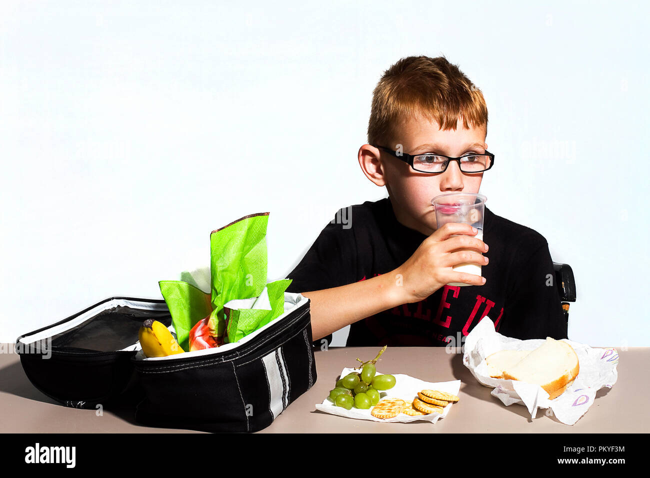 Young boy having lunch at school Stock Photo - Alamy