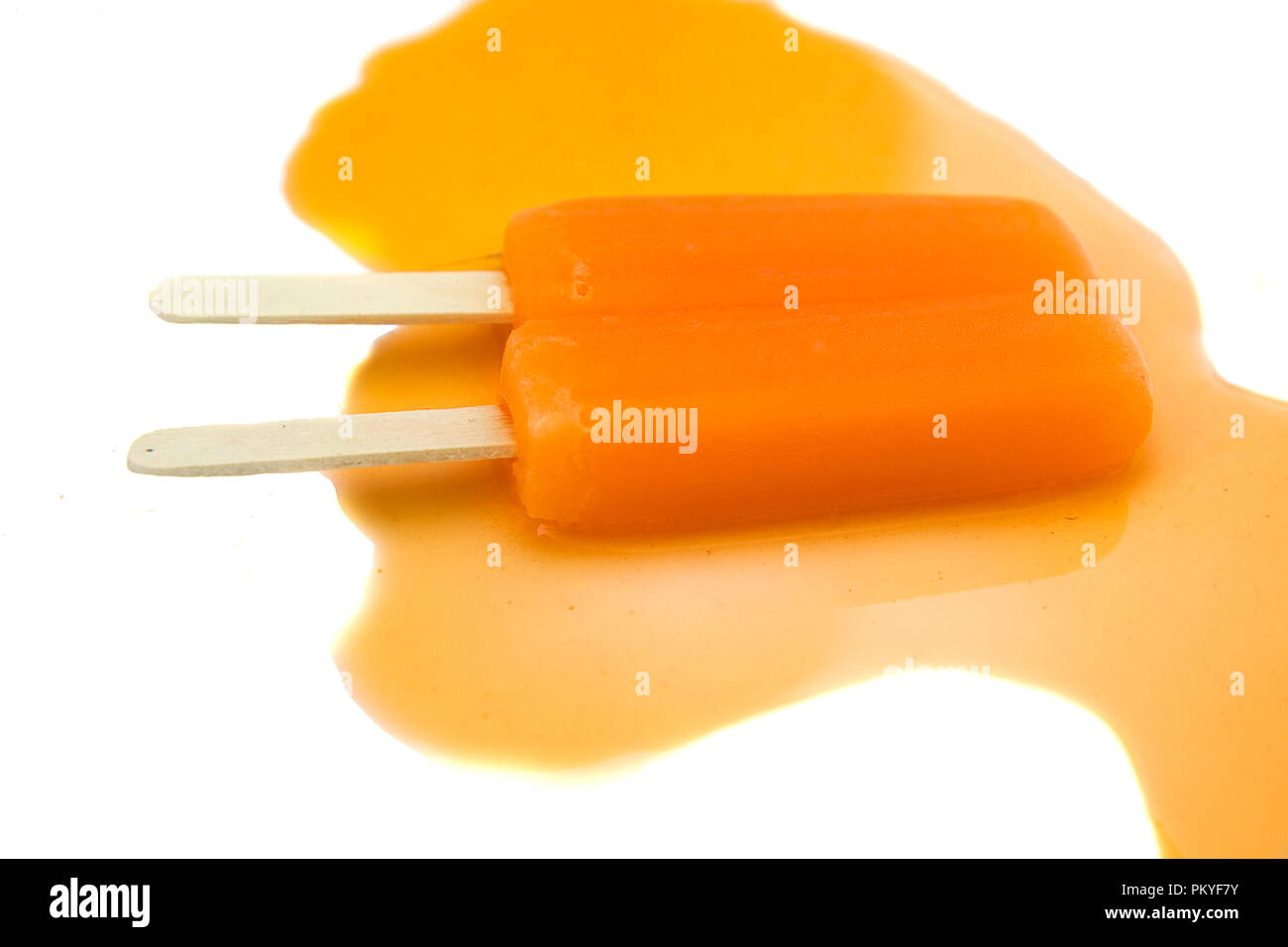 Orange Popsicle left melting in sun.isolated on white background Stock ...