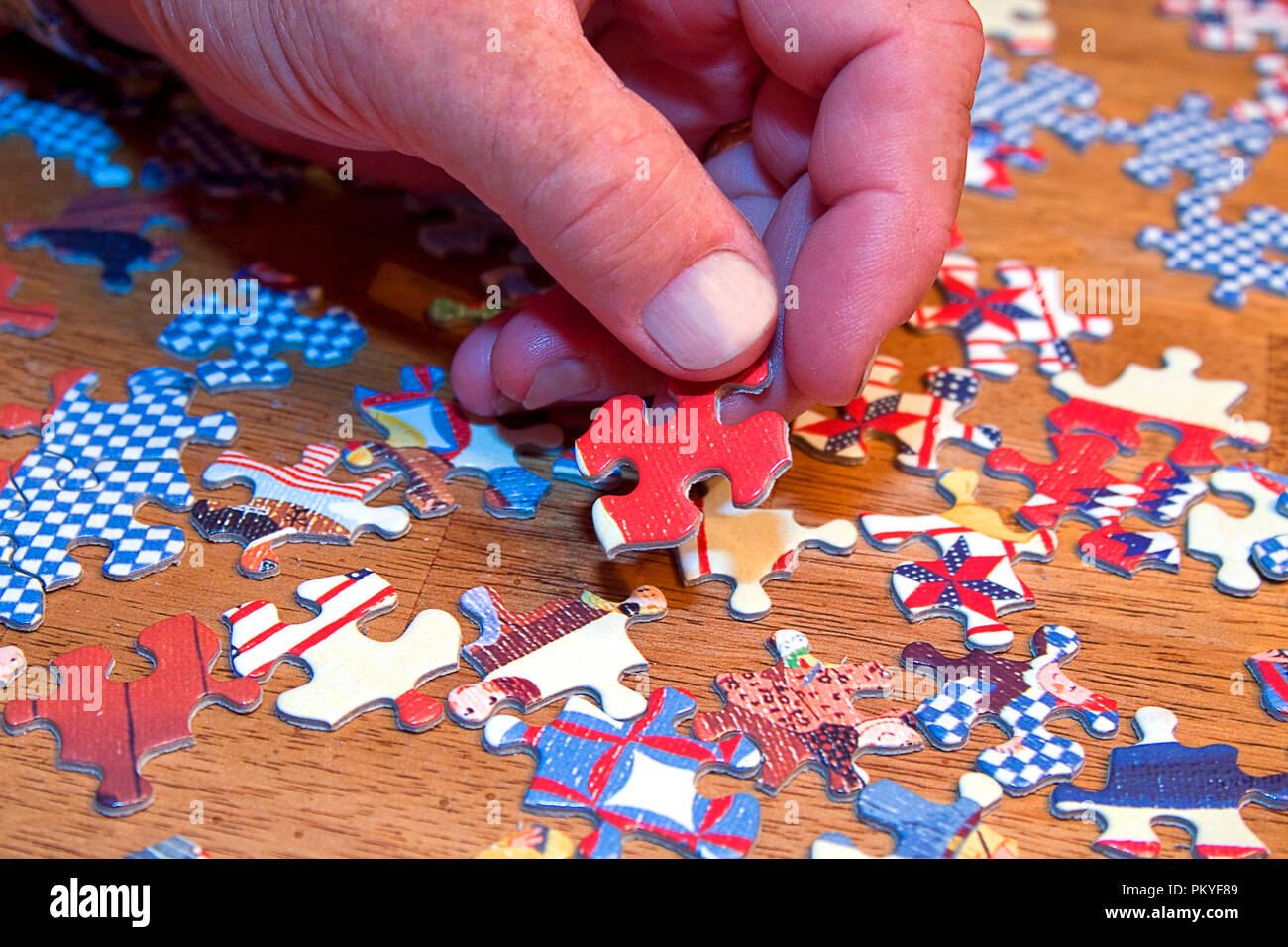 Closeup of man's hand putting puzzle pieces together Stock Photo - Alamy