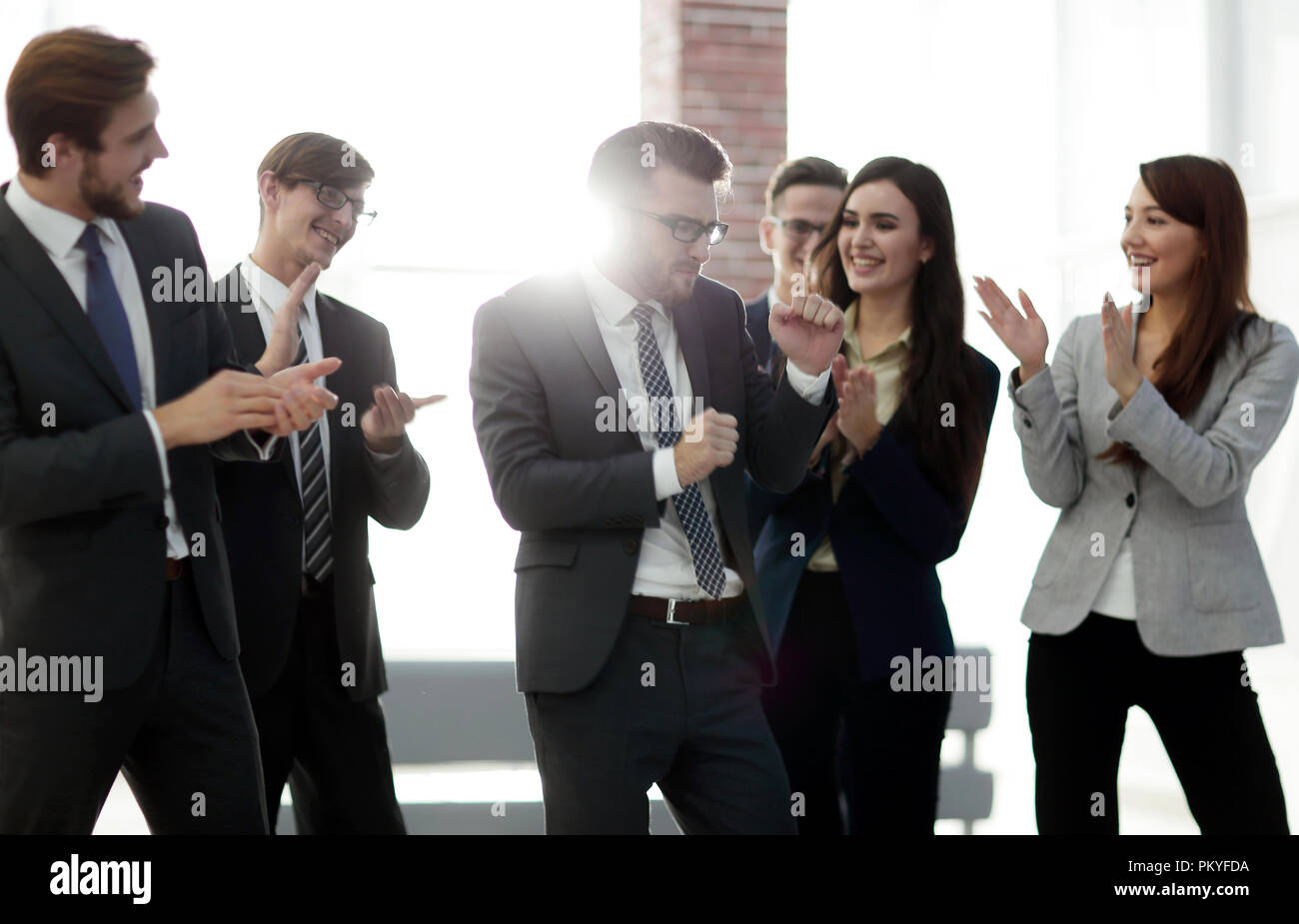 A team of business people congratulating each other Stock Photo - Alamy