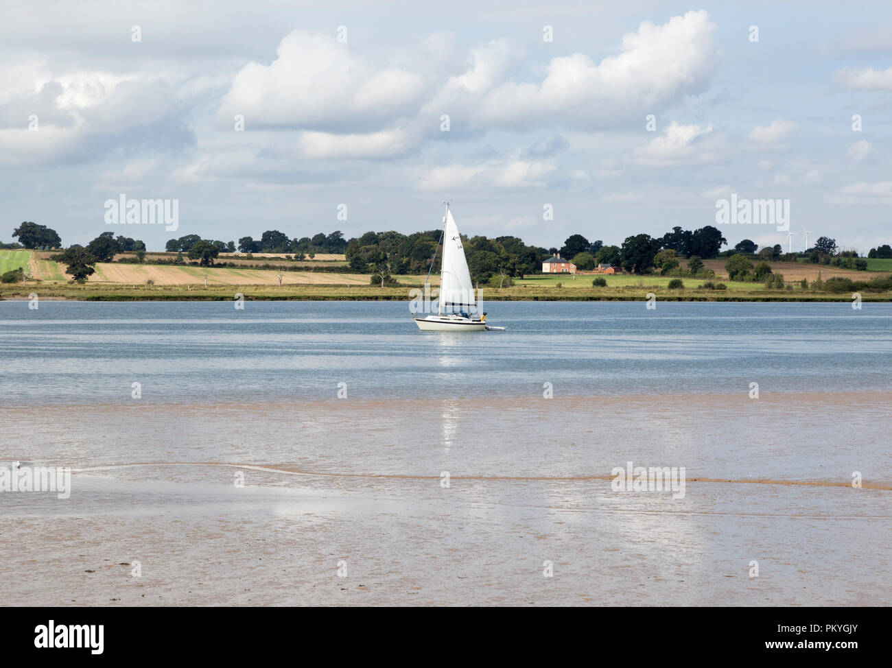 Summer landscape view of one small sailing yacht boat on River Deben ...