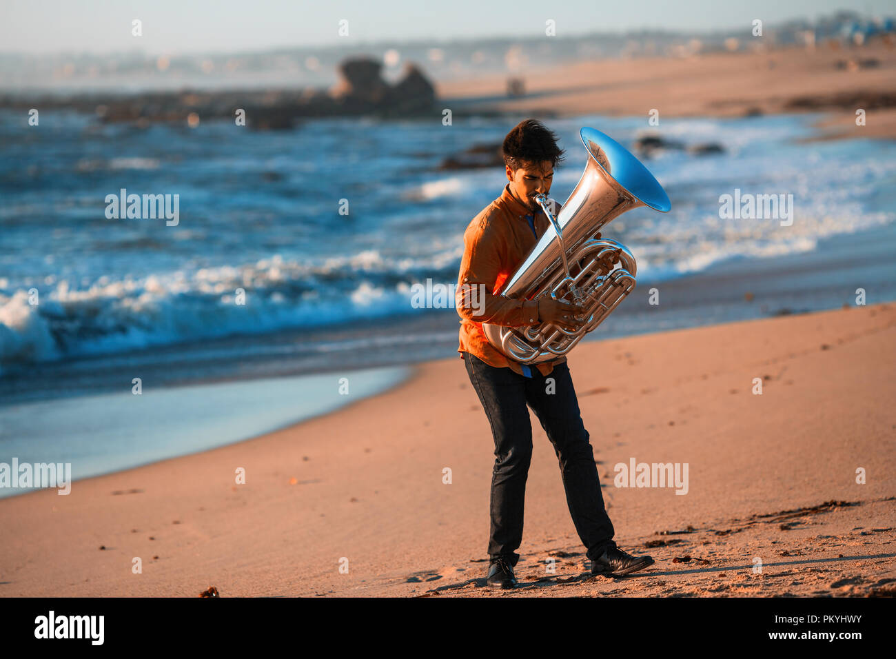 Musician instrumentalist playing the Tuba on the sea coast Stock Photo ...