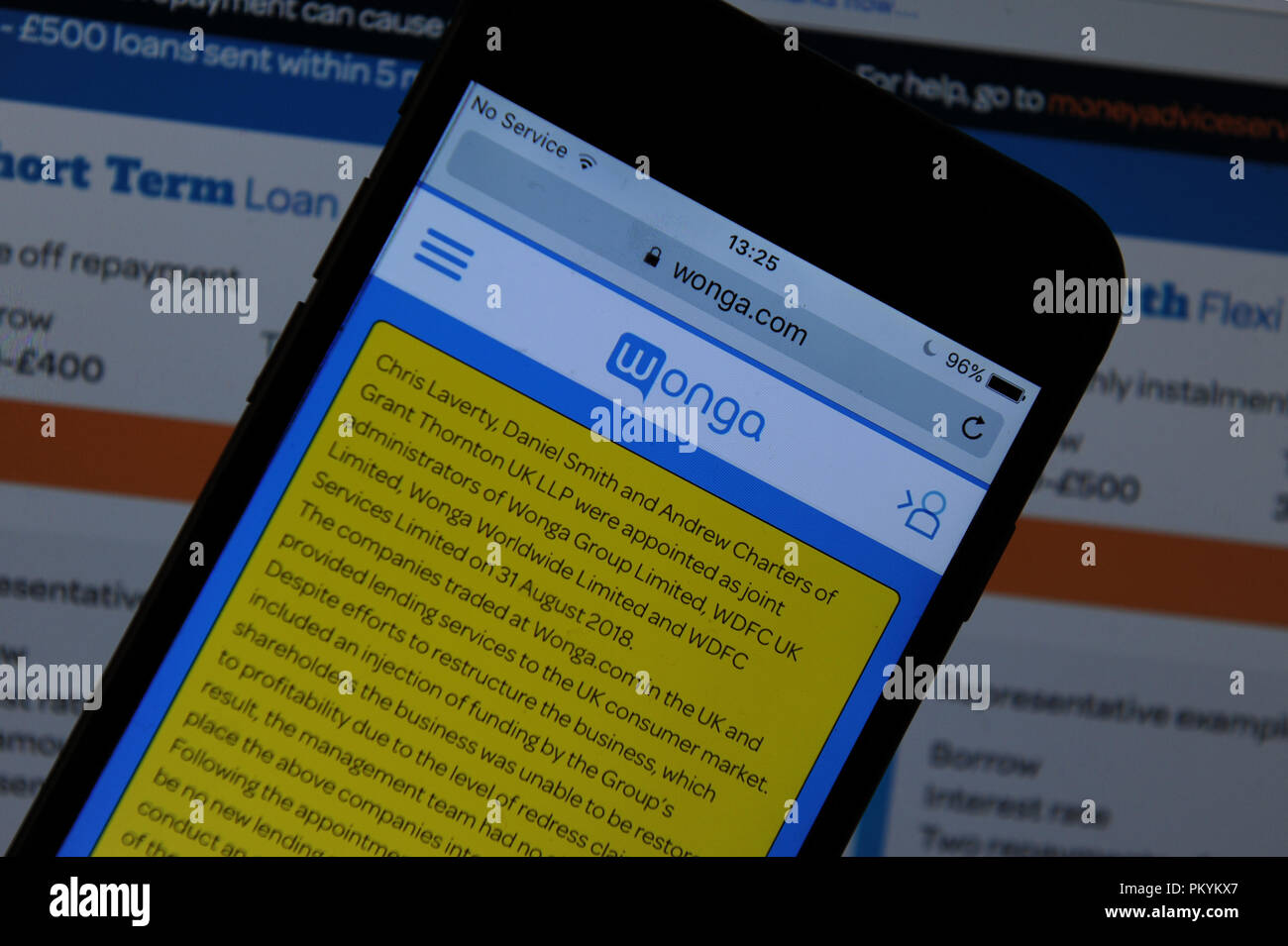 The Wonga website seen on a mobile phone and a computer screen Stock ...