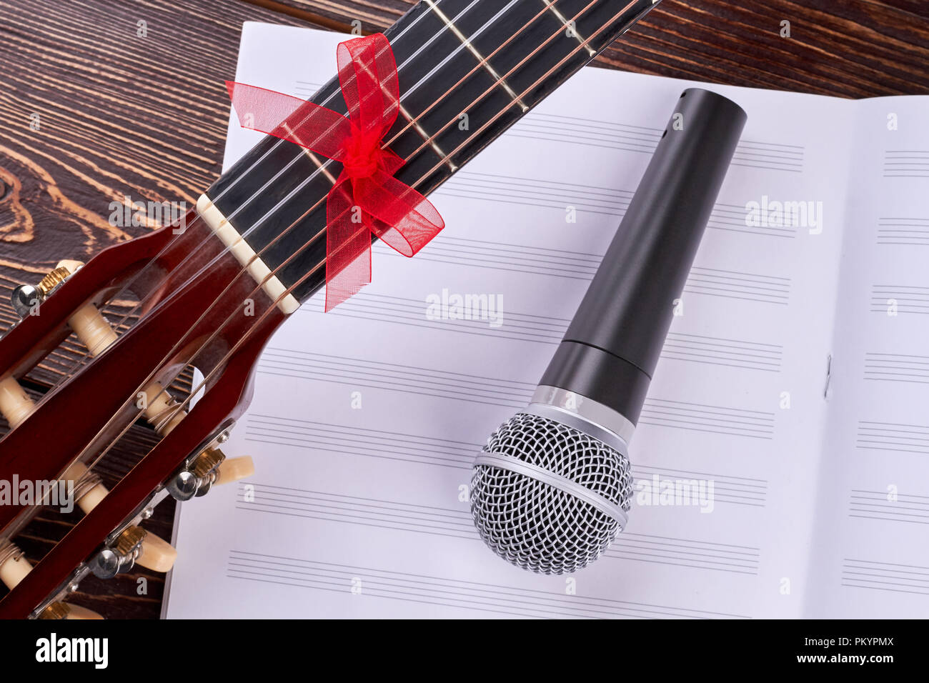 Guitar, notes sheet and microphone. Vocal microphone on music notes ...