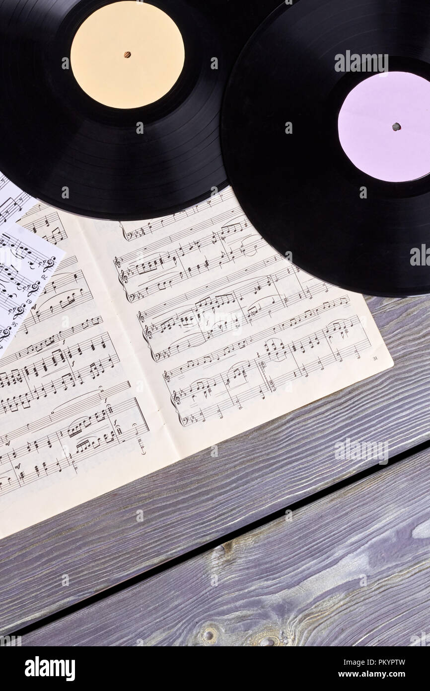 Vinyl records and musical notes sheets. Vinyl disc, musical notes pages ...