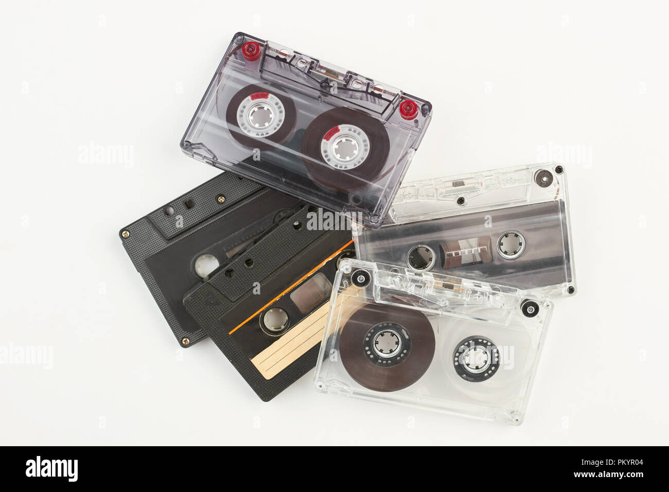 Pile of retro cassette tapes. Stack of old tape cassetes over white ...
