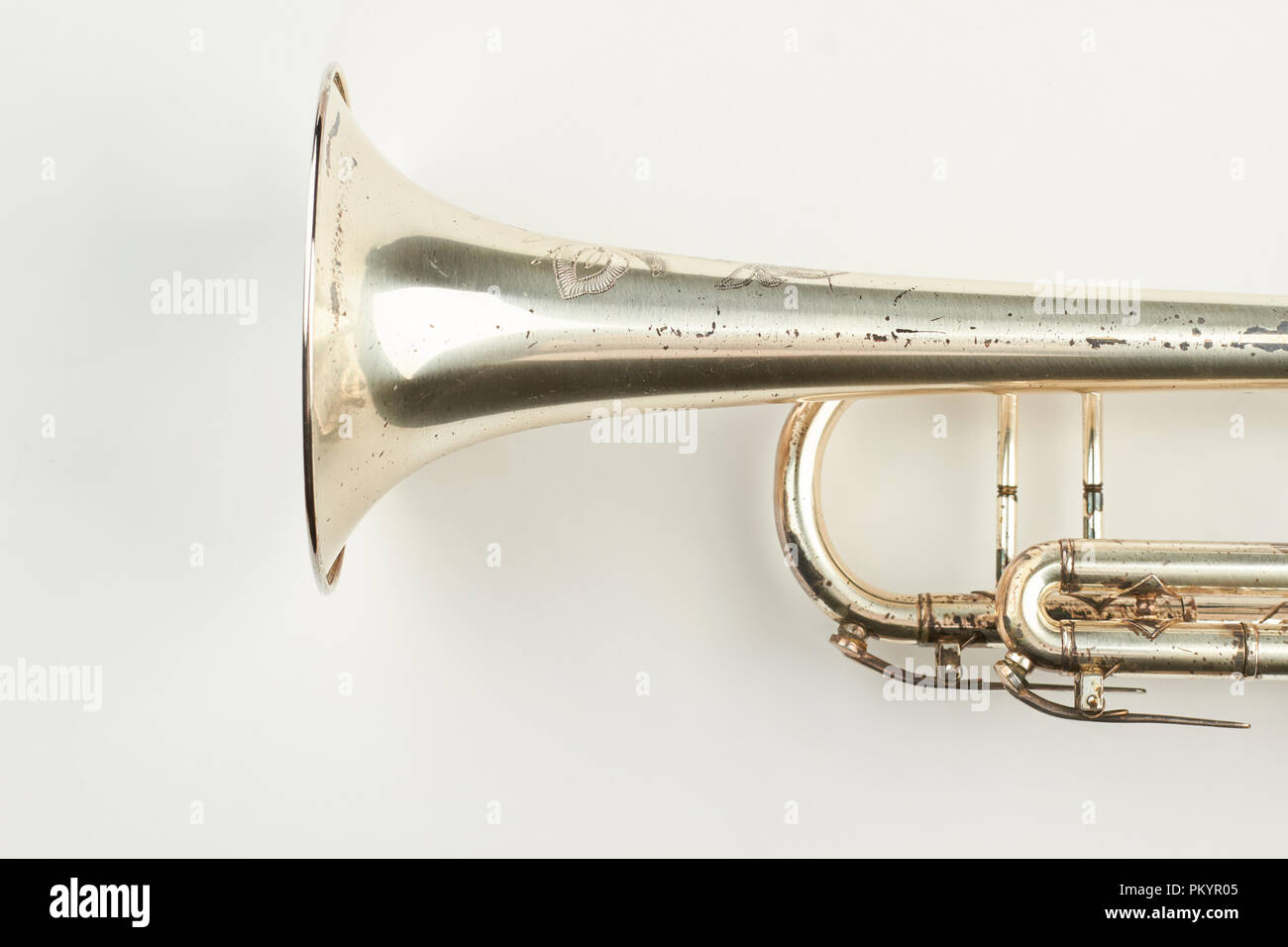 Part of rusty trumpet instrument. Old classical trumpet on light ...