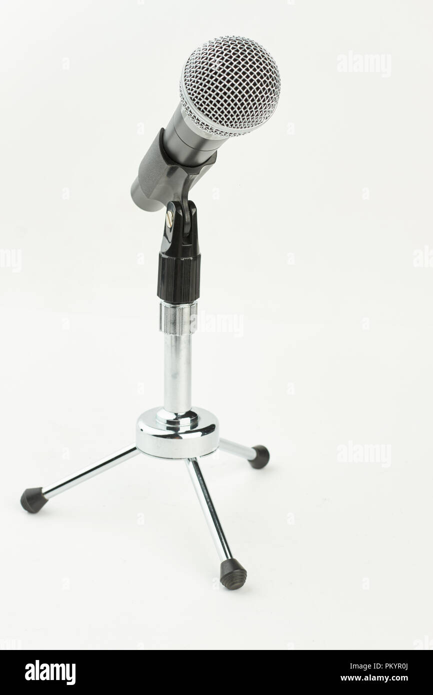 Gray microphone on short stand. Mini microphone isolated on white ...