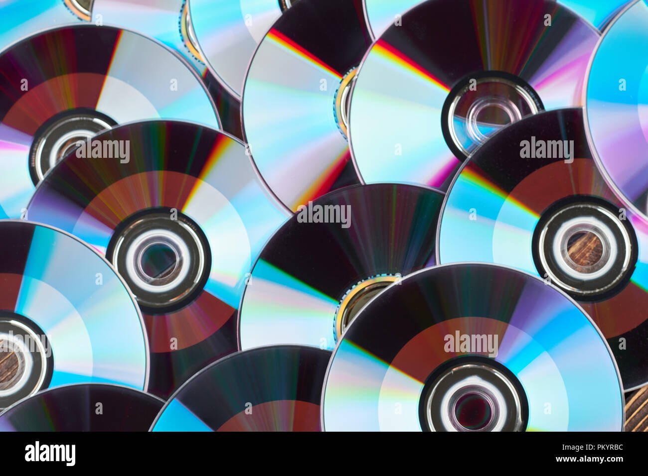 Close up group of DVD discs. Colorful compact disks background. Shiny ...