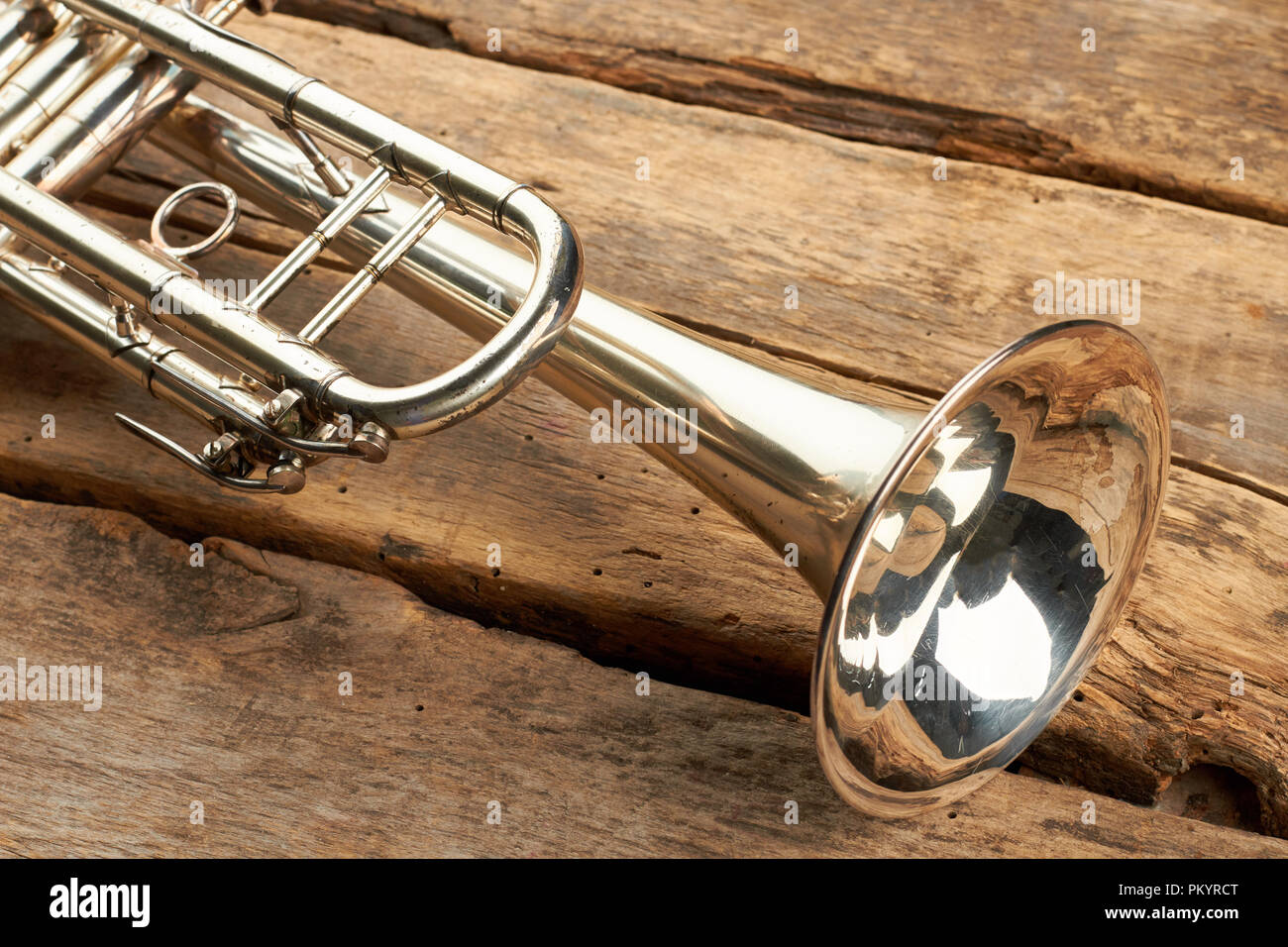 Close up trumpet on rustic wooden floor. Classical trumpet with mirror ...