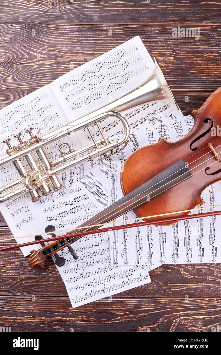 Violin, trumpet and musical notes sheets Stock Photo - Alamy