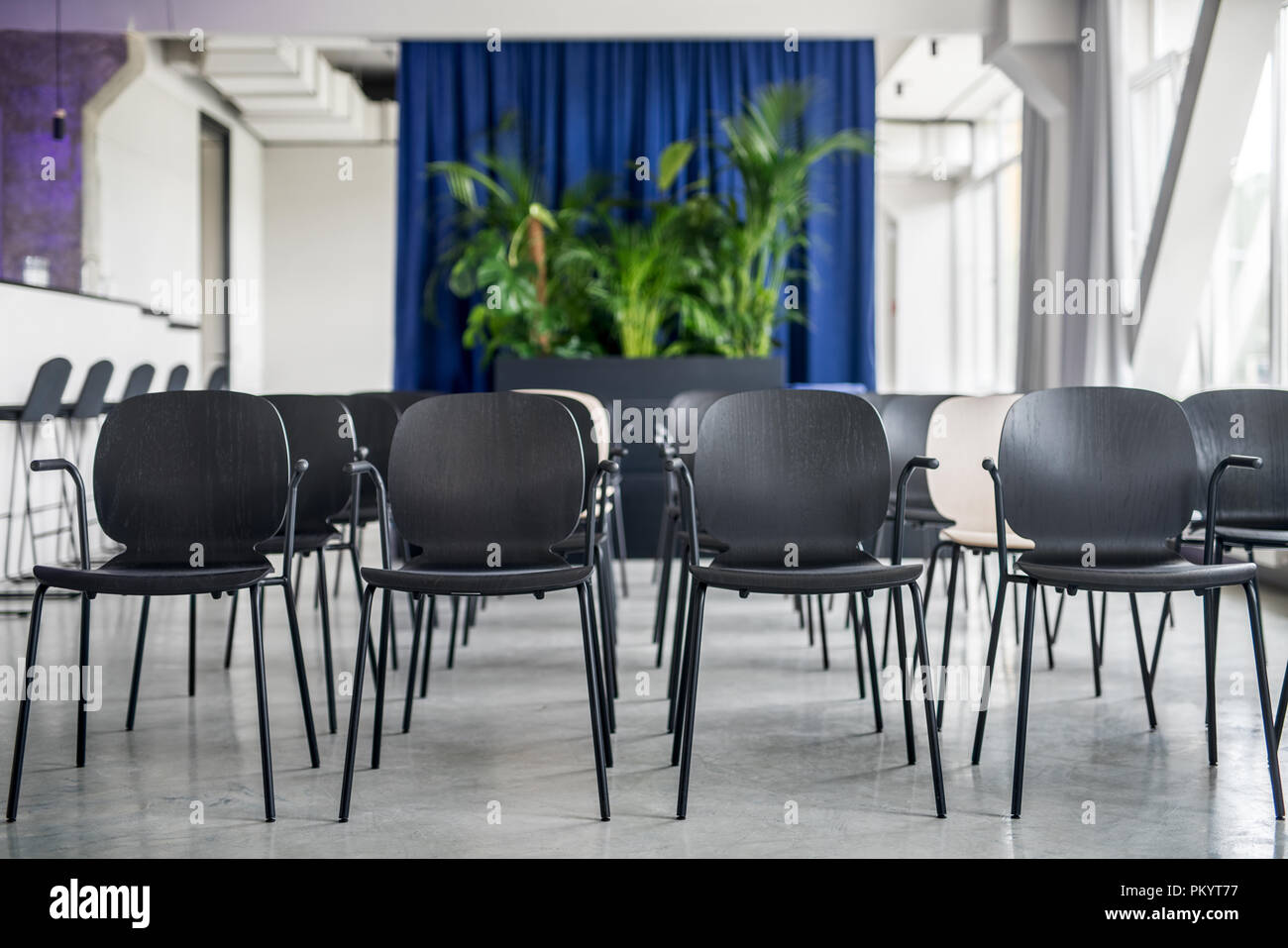 Trendy conference hall in a loft style with gray walls and a concrete ...