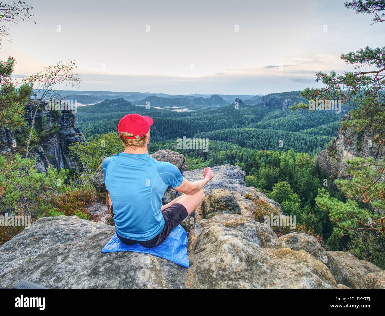 Man meditating on mountain top hi-res stock photography and images - Alamy