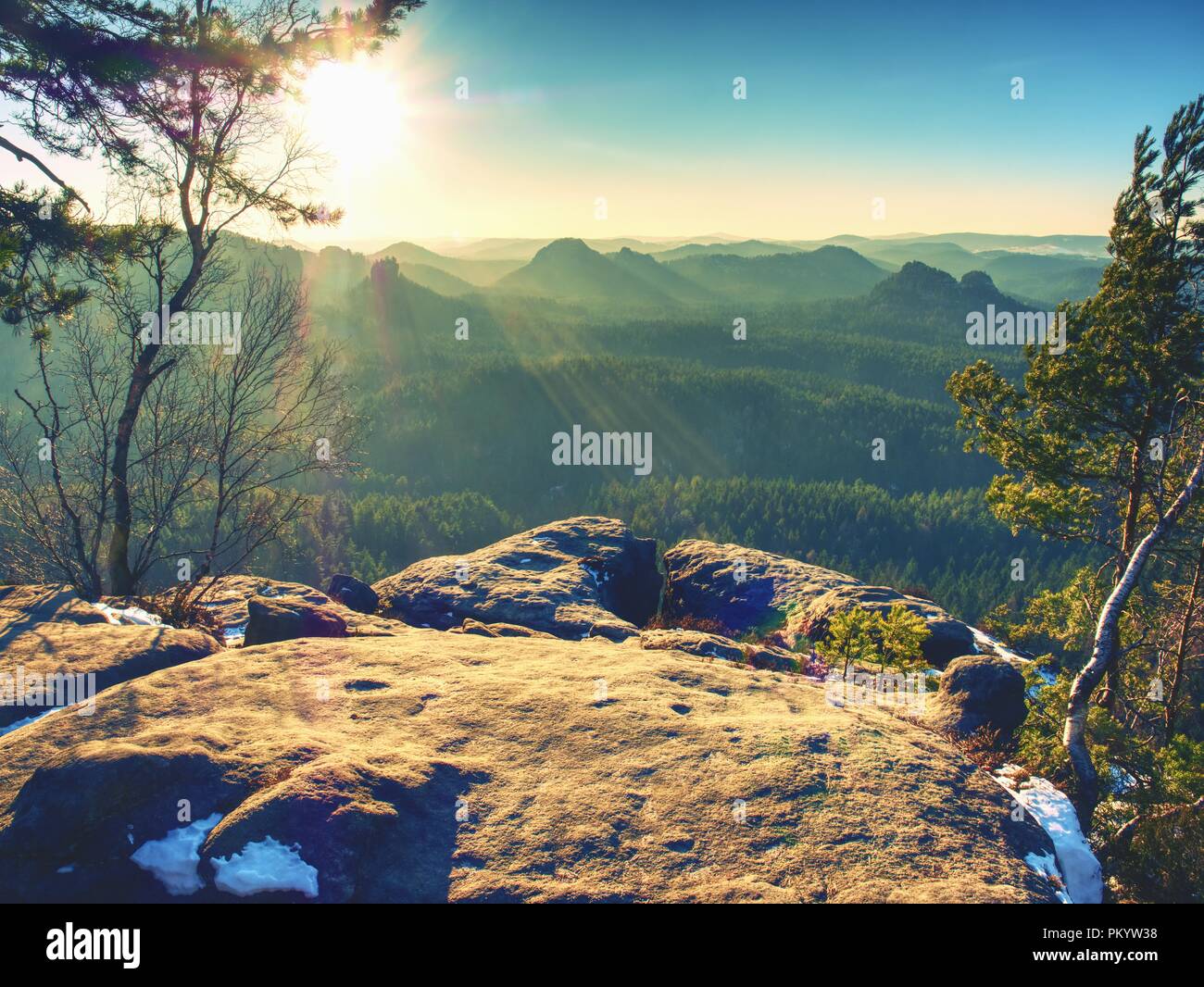 Spring morning nature. The cracked sandstone cliff above forest valley ...