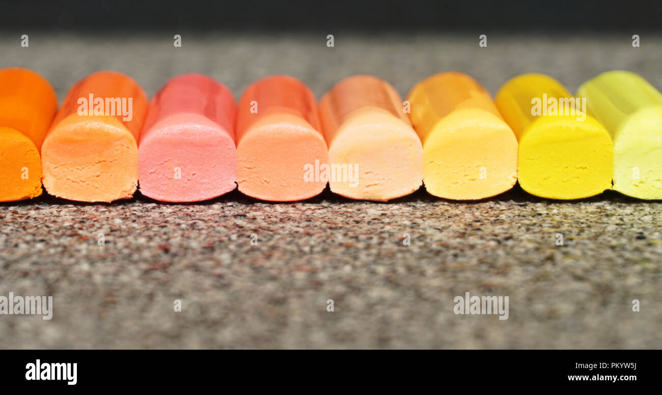 Colorful background with wax pencil sticks in the pastel color lined up ...
