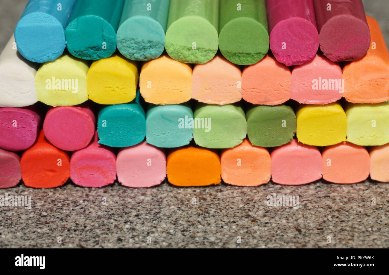 Coloring waxy pencil sticks in many different colors stacked up on the ...